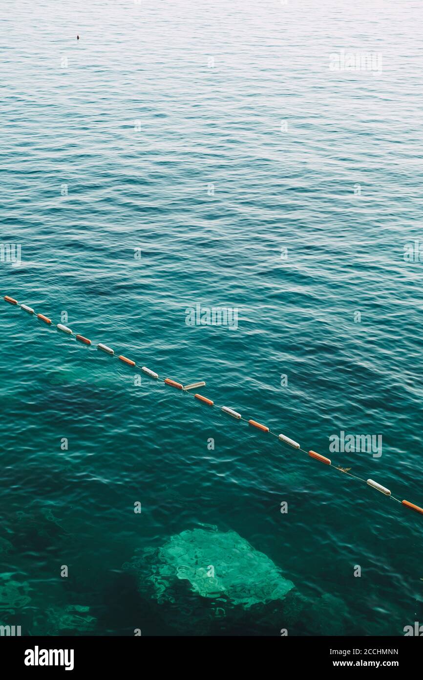 A chain of buoys swims in the sea Stock Photo - Alamy
