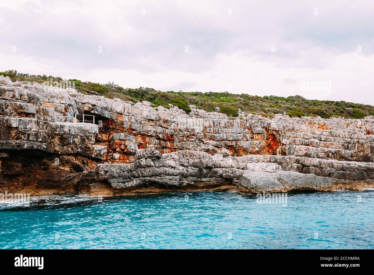 Rocky coast with azure blue water Stock Photo - Alamy