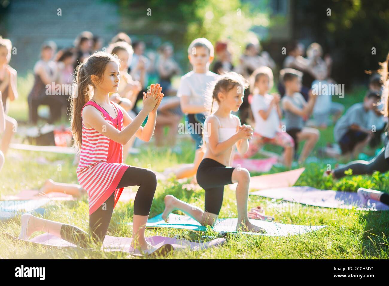 Yoga classes outside on the open air. Kids Yoga Stock Photo - Alamy