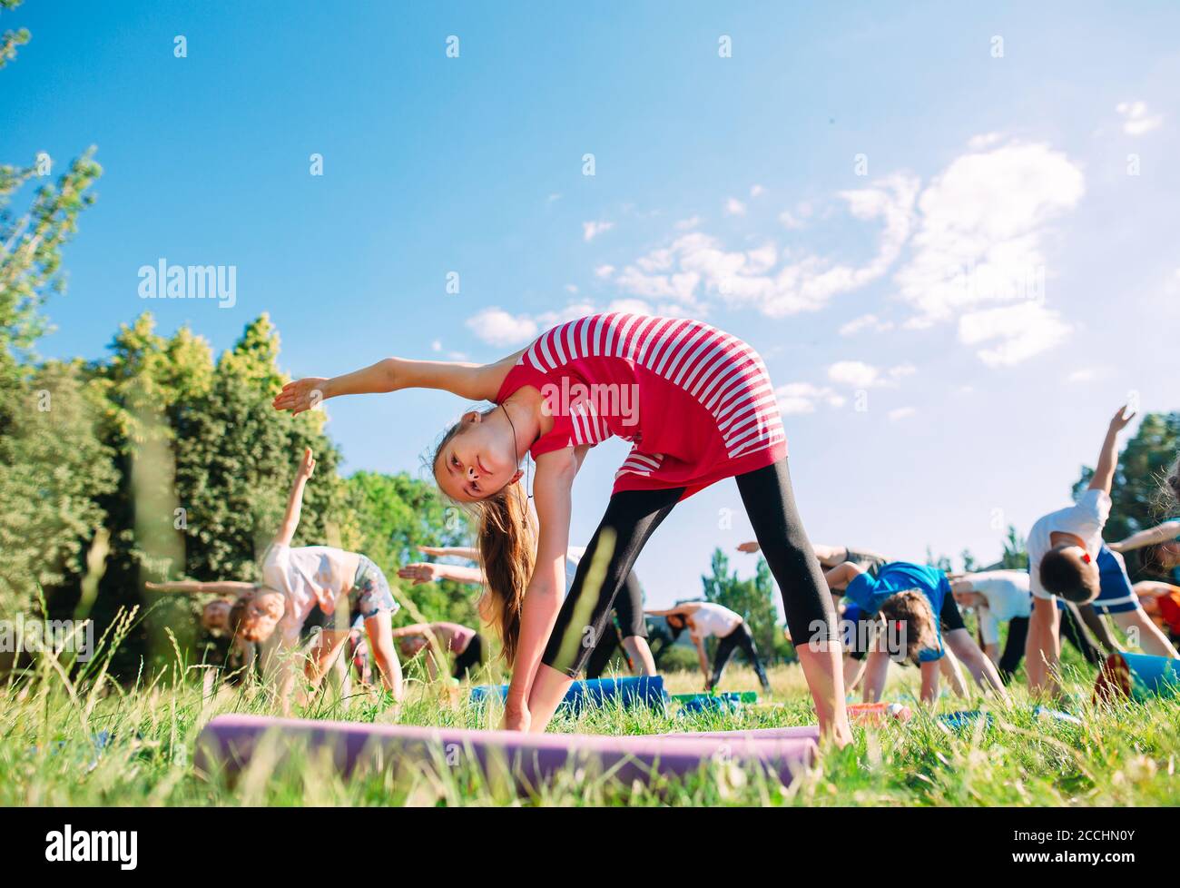 Yoga classes outside on the open air. Kids Yoga Stock Photo - Alamy