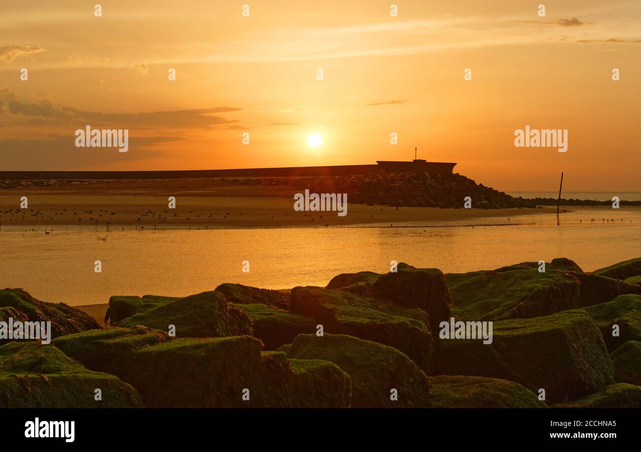 Sunset over sea bay. Dramatic lighting, sunlight rays and beautiful ...