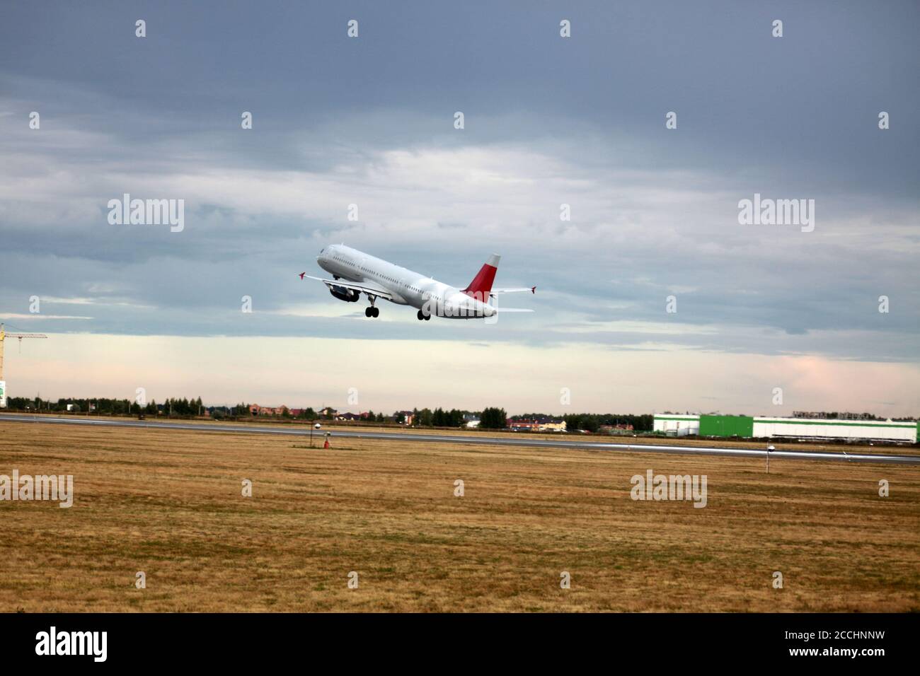 Passenger plane takes off from the airport runway. Side-view of ...