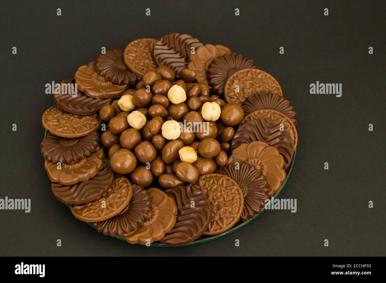 Milky and bitter round shape chocolate Madlen,designed on glass plate ...