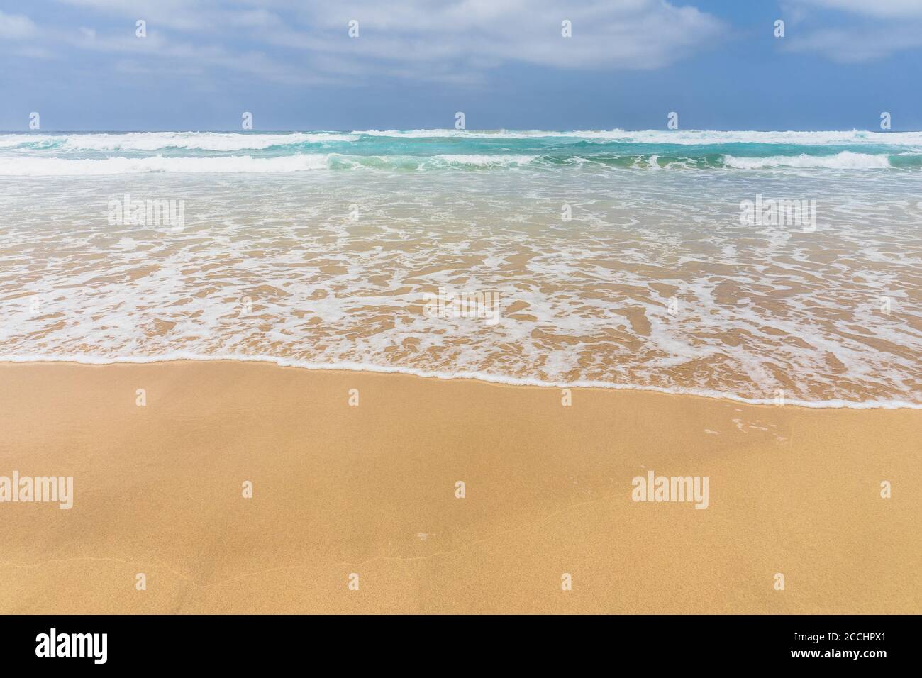 View of the ocean waves, sandy beach and sky Stock Photo - Alamy