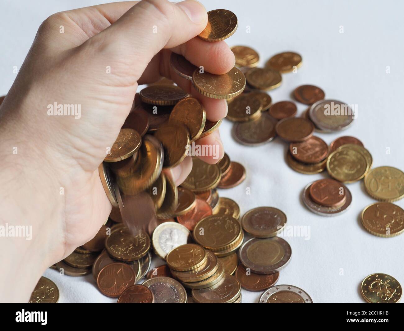 Hand handing Euro coins money (EUR), currency of European Union Stock ...