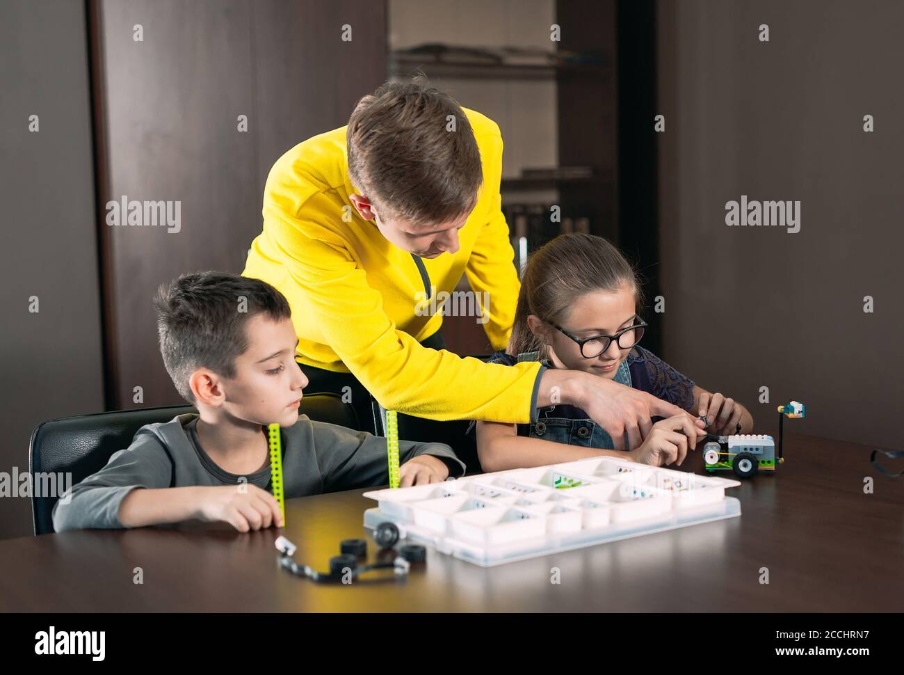 Kids creating robots with teacher. Early development, diy, innovation ...