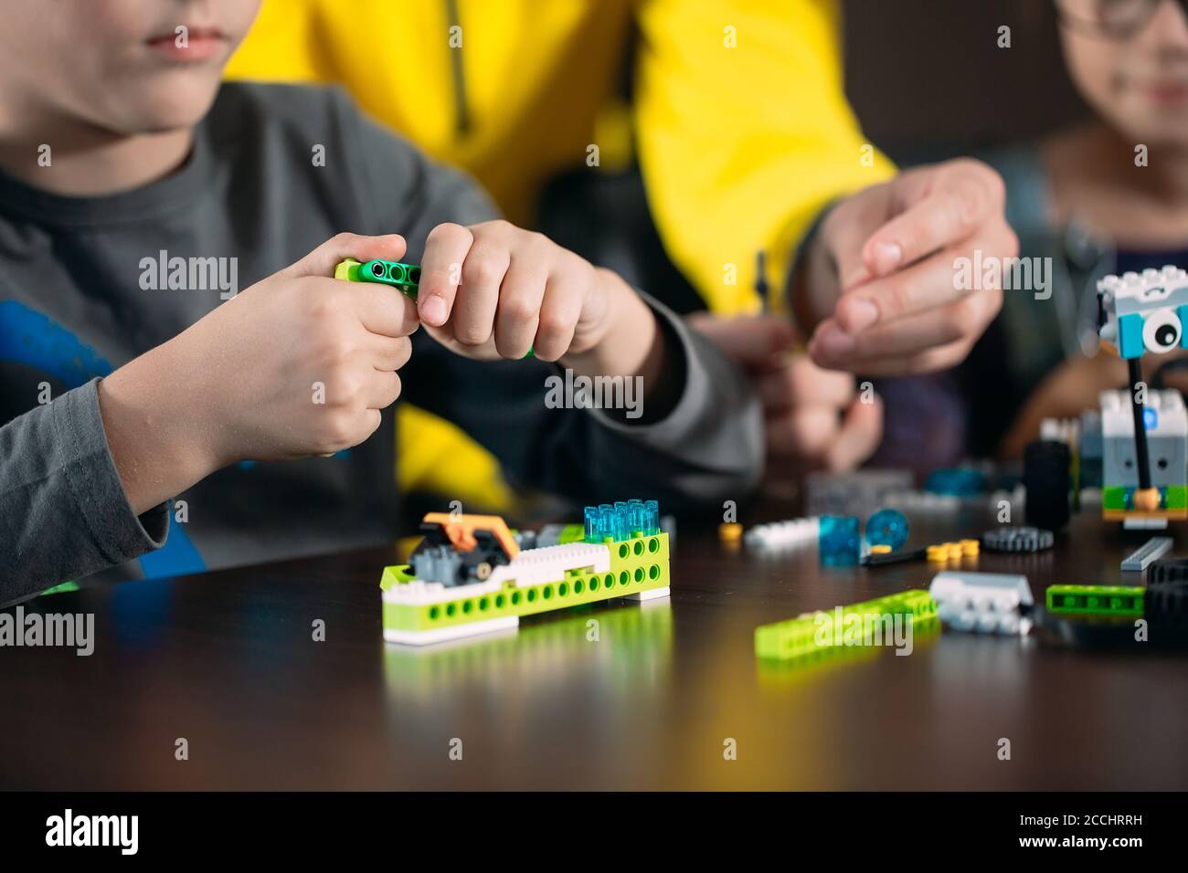 Kids creating robots with teacher. Early development, diy, innovation ...