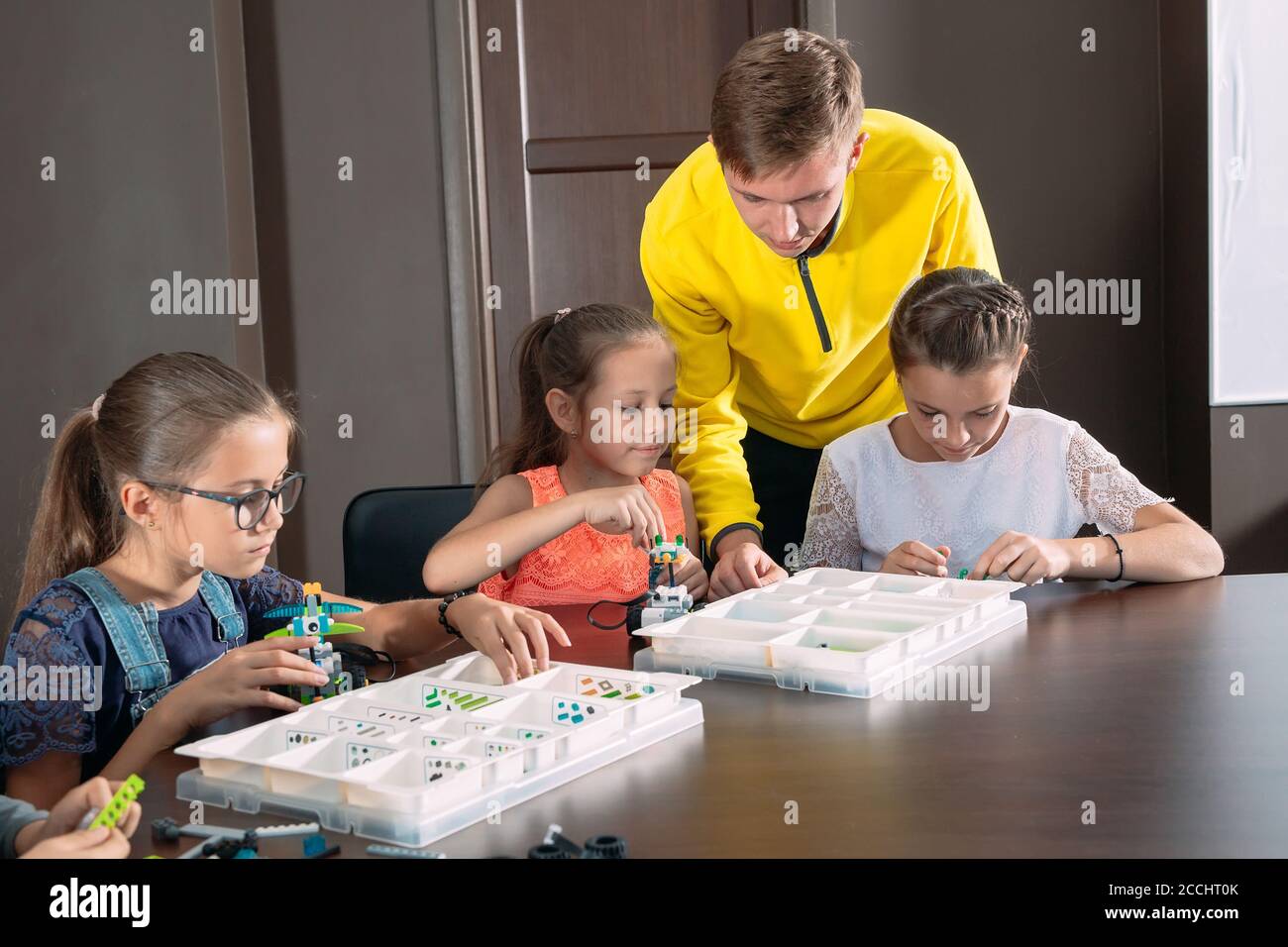 Kids creating robots with teacher. Early development, diy, innovation ...