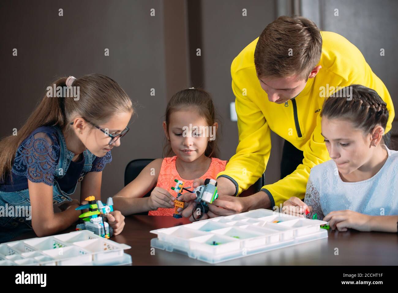 Kids creating robots with teacher. Early development, diy, innovation ...