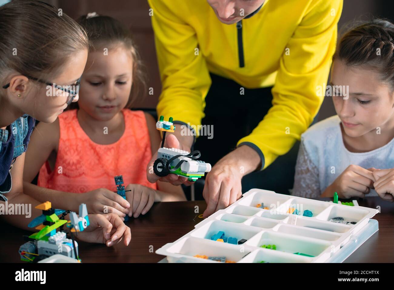 Kids creating robots with teacher. Early development, diy, innovation ...