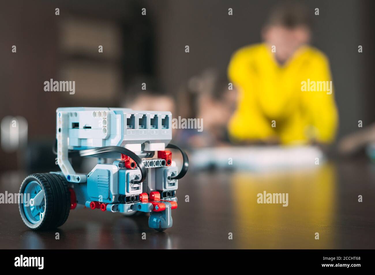 Kids creating robots with teacher. Early development, diy, innovation ...