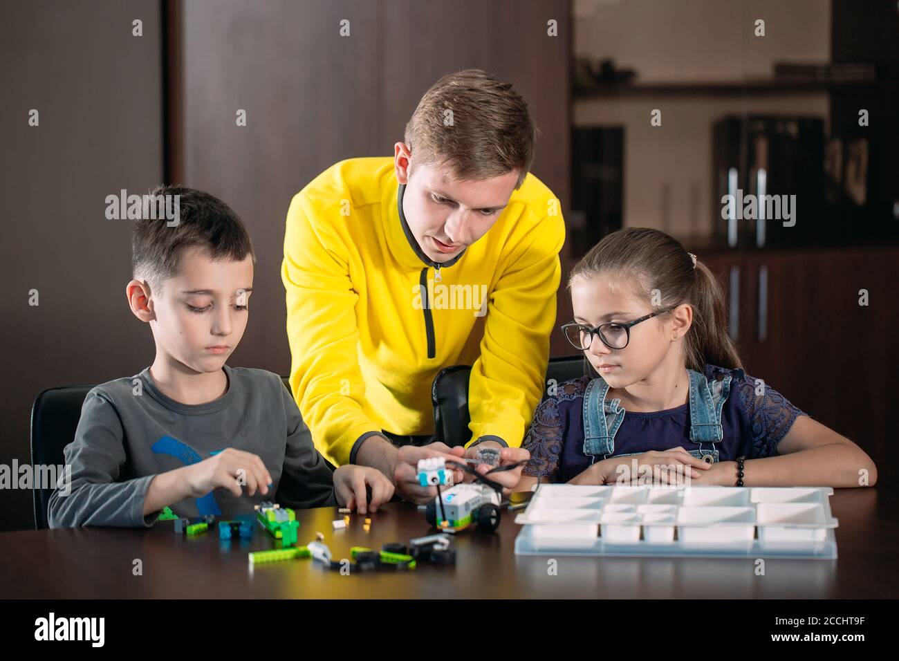 Kids creating robots with teacher. Early development, diy, innovation ...