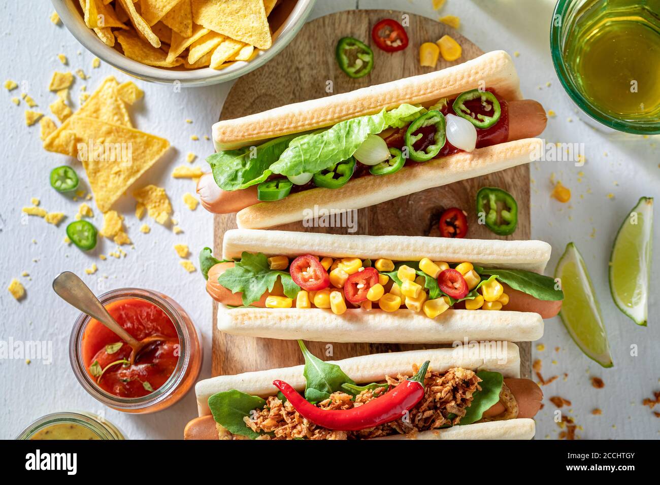 Tasty hot dogs with vegetables, herbs and sauce Stock Photo - Alamy