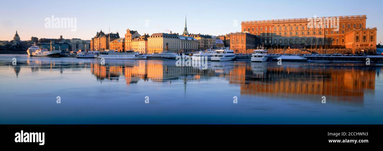 Boats anchored along Skeppsbron at sunrise with Royal Palace and Old ...