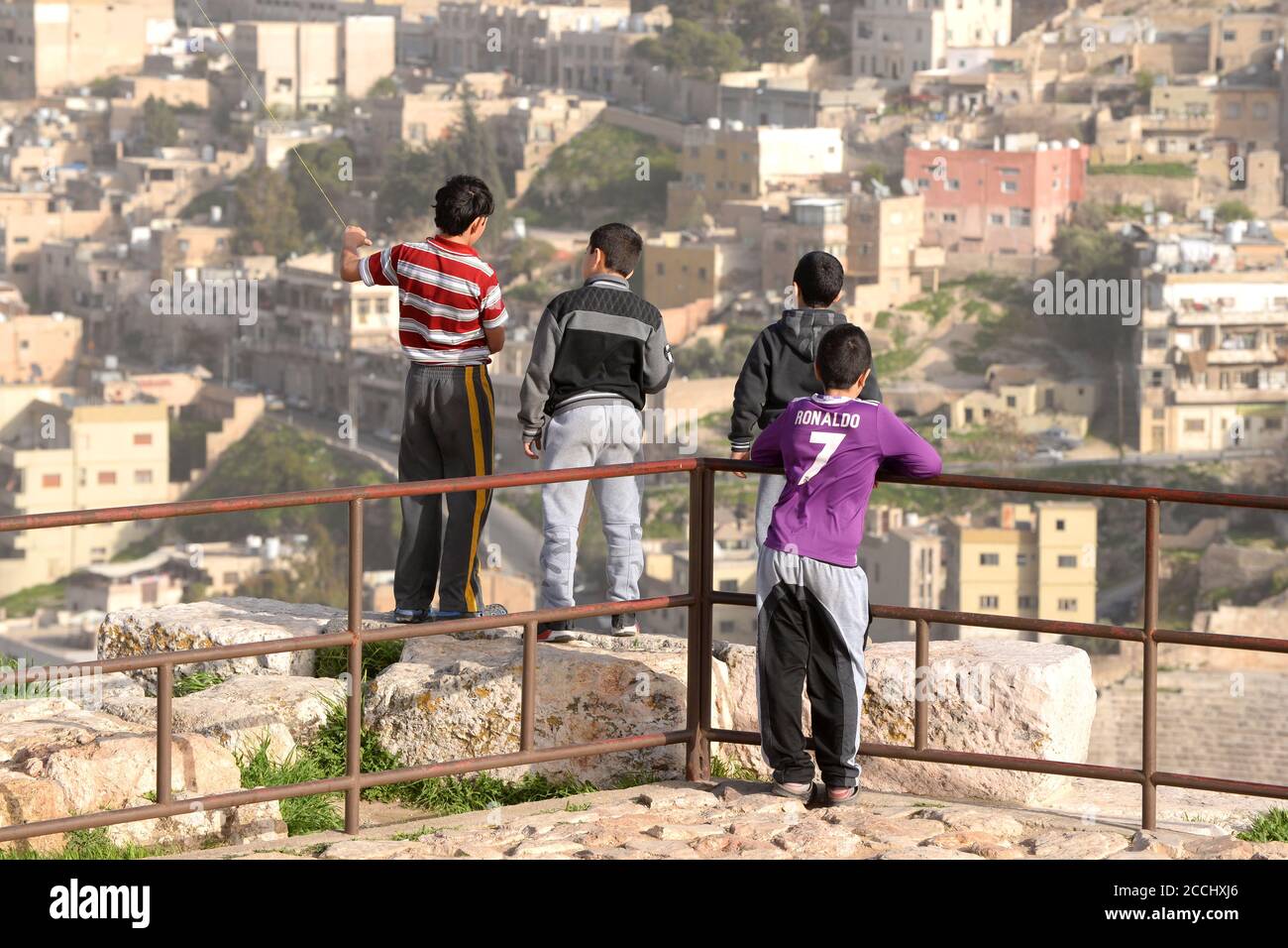 Group of local Jordanian children and city skyline out of focus from ...
