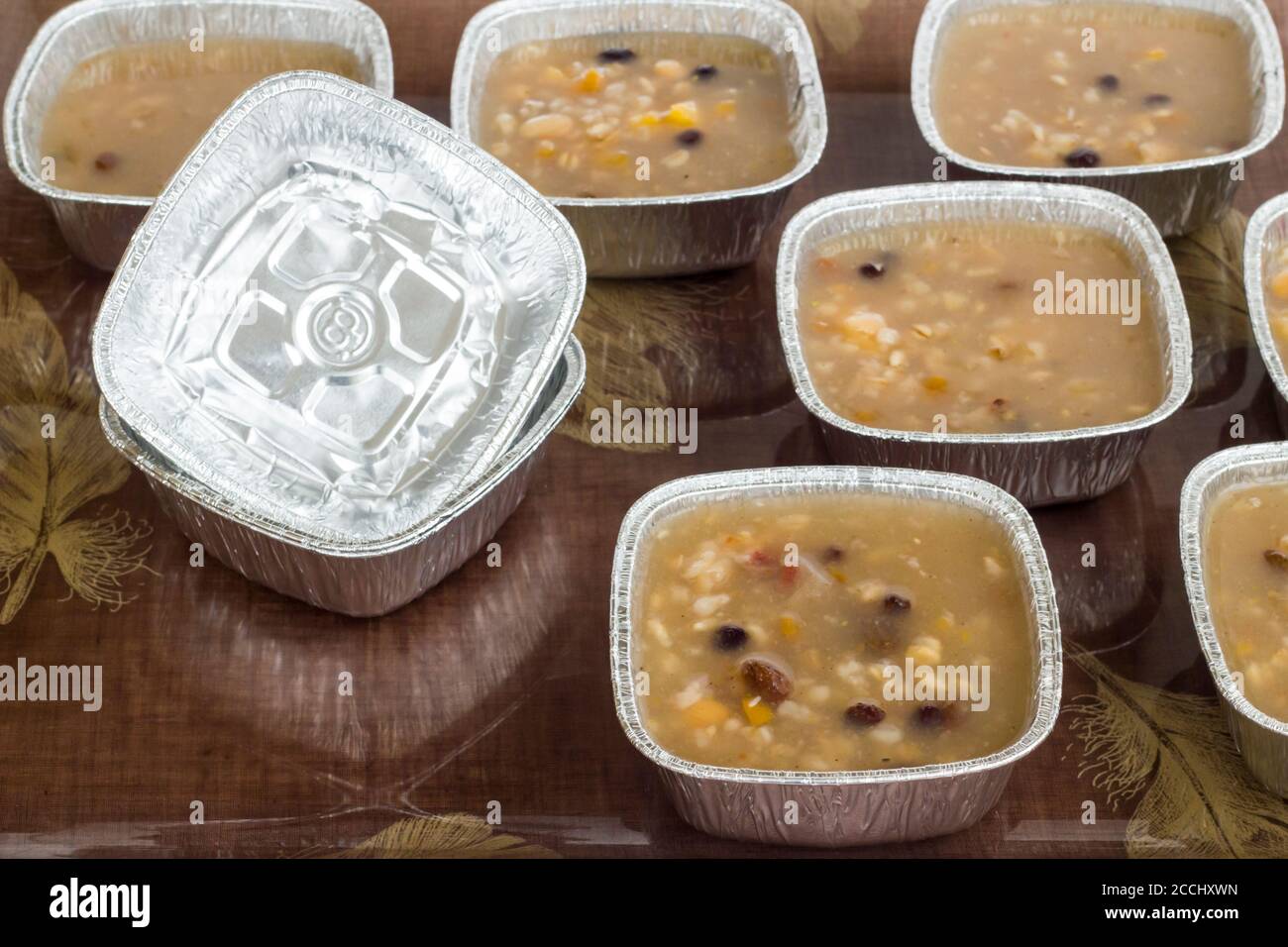 Traditional Turkish Dessert Asure on tray with ladle and aluminum bowls ...