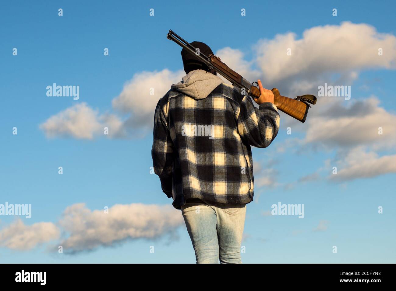 Back view. Hunter man with hunt hunting rifle. Male with a gun. Shooter ...