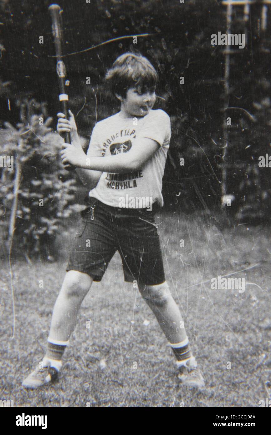 Fine 1970s vintage black and white photography of a young man swinging ...