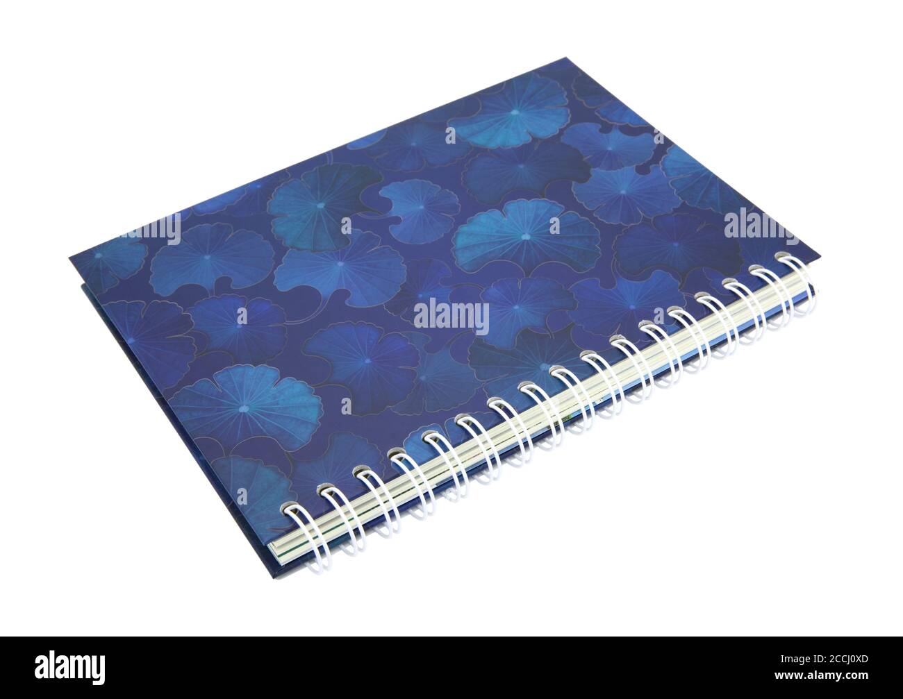 Blue spiral notebook with lotus leaves pattern on cover isolated on ...