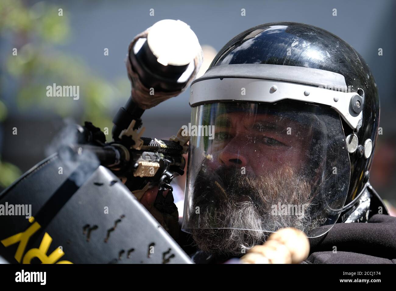 USA. 22nd Aug, 2020. Proud Boy Alan Swinney fires a paintball gun at ...