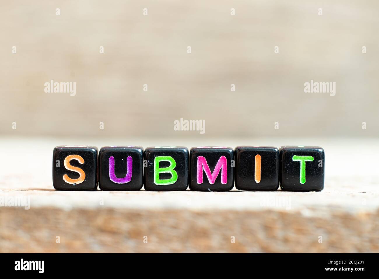 Black bead with color letter in word submit on wood background Stock ...