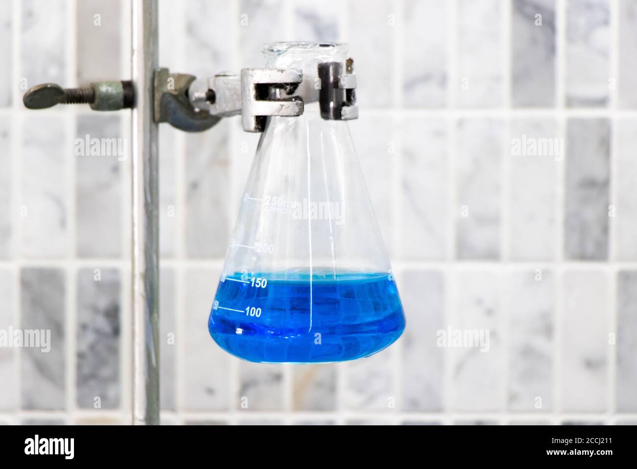 Erlenmeyer flask contain blue color solution on tile background Stock ...