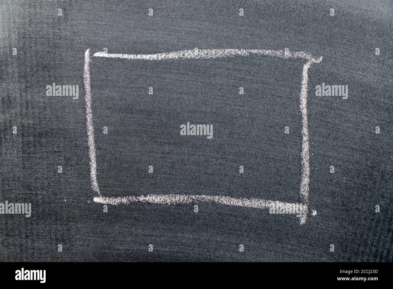 White color chalk hand drawing in square shape on black board ...