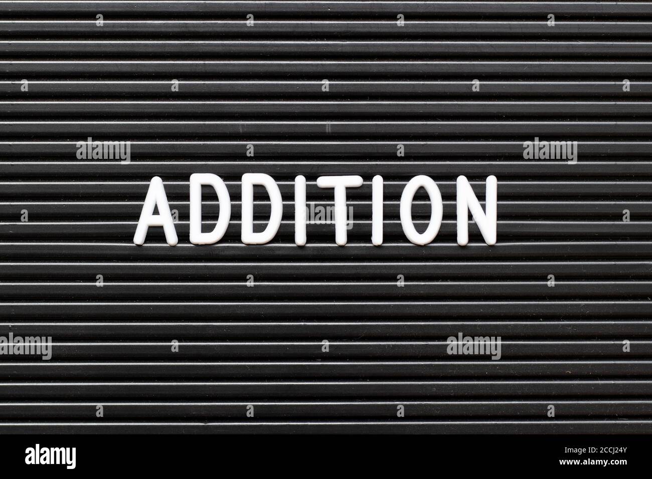 Black felt board with white alphabet in word addition background Stock ...