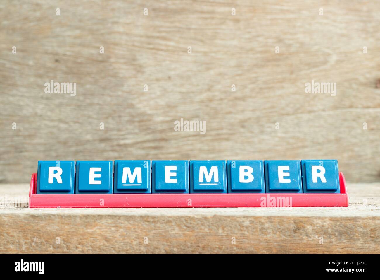 Tile letter on red rack in word remember on wood background Stock Photo ...