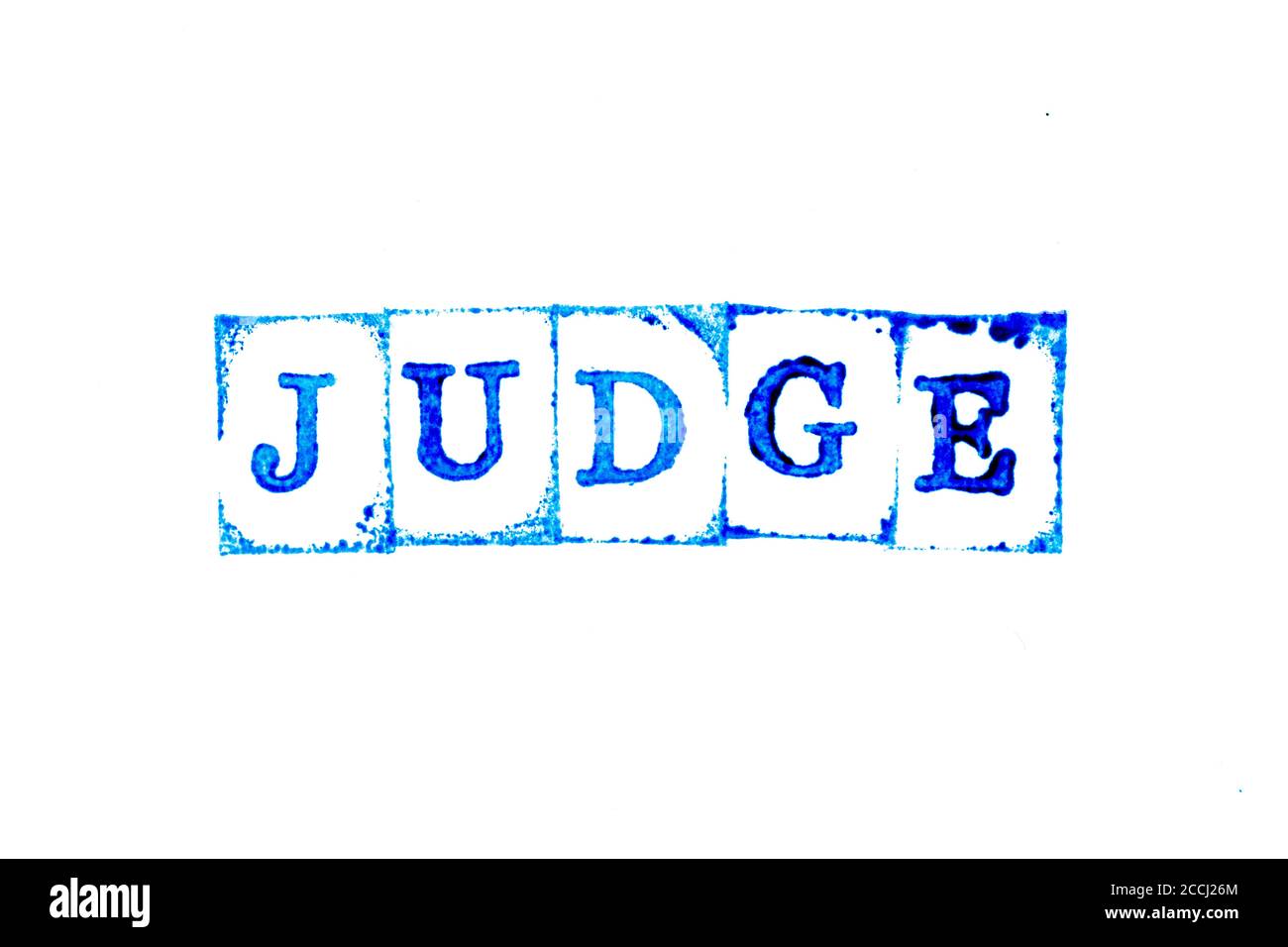 Blue color ink of rubber stamp in word judge on white paper background ...