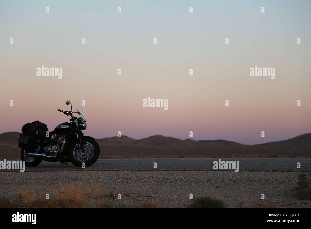 A 2018 Triumph Bonneville Speedmaster on a road trip during a spectacular sunset Stock Photo - Alamy