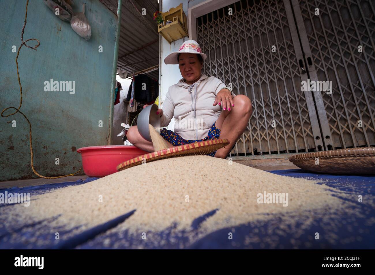 Hoi An / Vietnam - January 18, 2020: Vietnamese woman squatting sifting ...