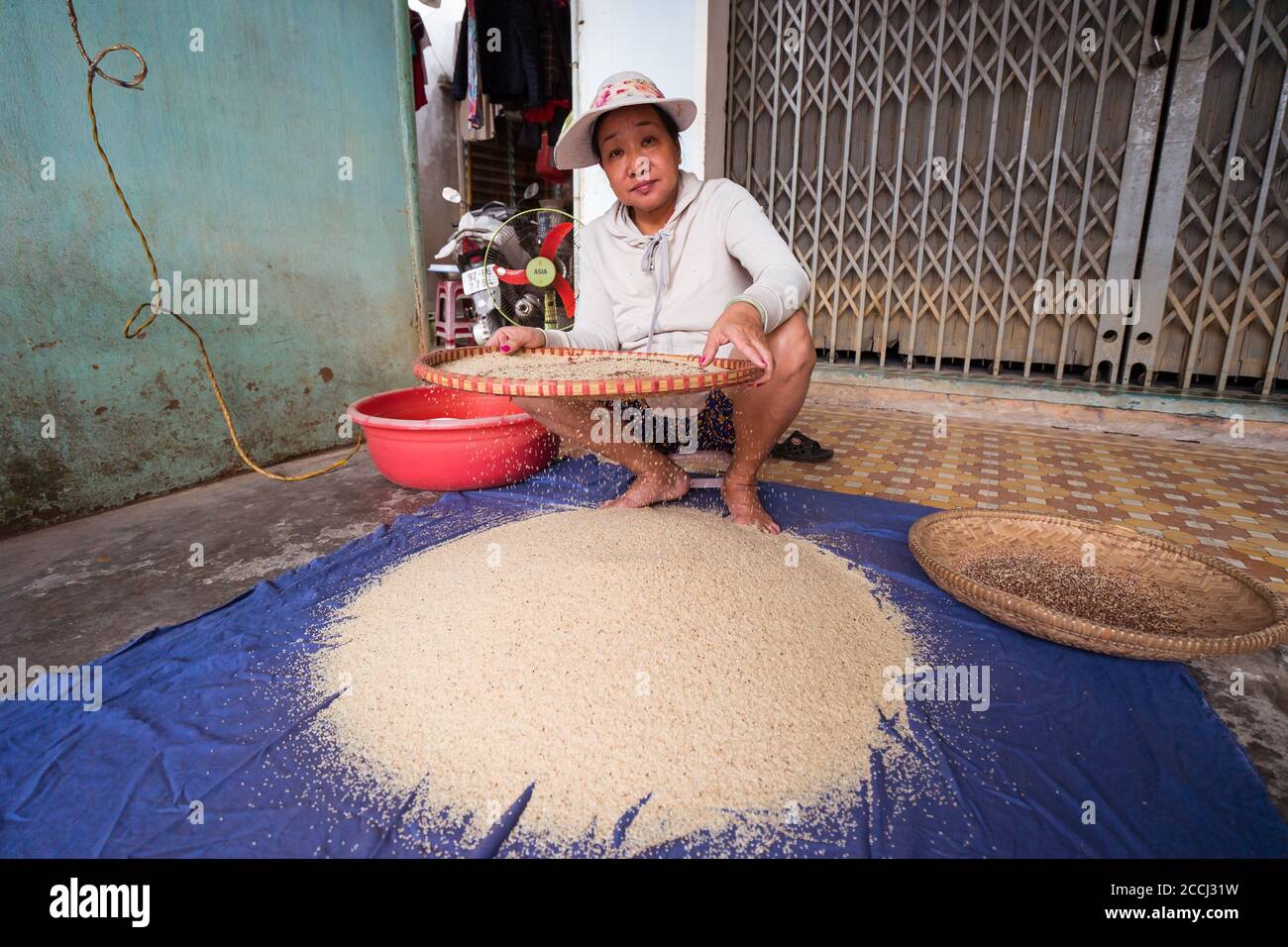 Hoi An / Vietnam - January 18, 2020: Vietnamese woman squatting sifting ...