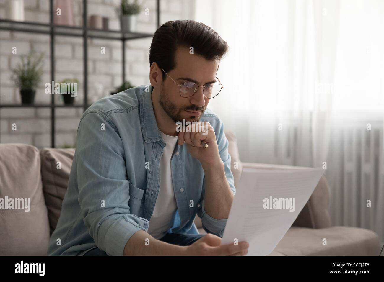 Worried man reading correspondence hi-res stock photography and images ...