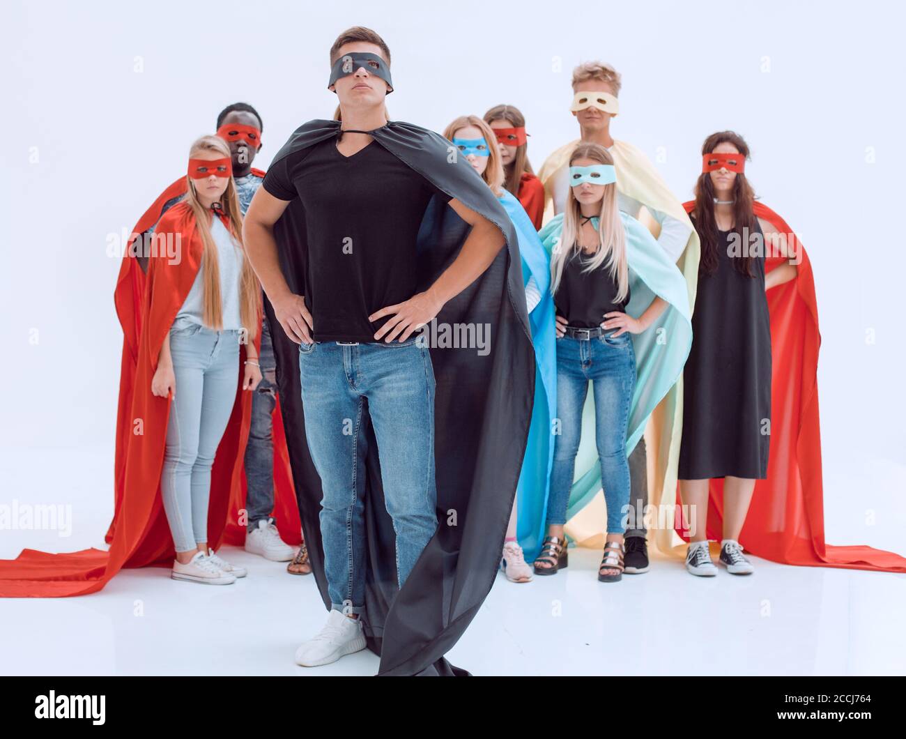 confident guy in a Superman Cape standing in front of his team Stock ...