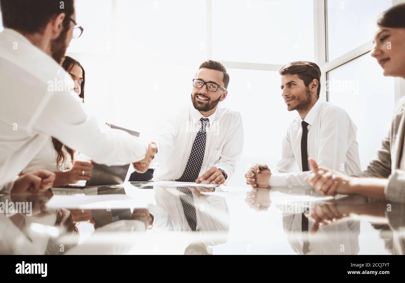 bottom view.handshake business partners over the Desk Stock Photo - Alamy
