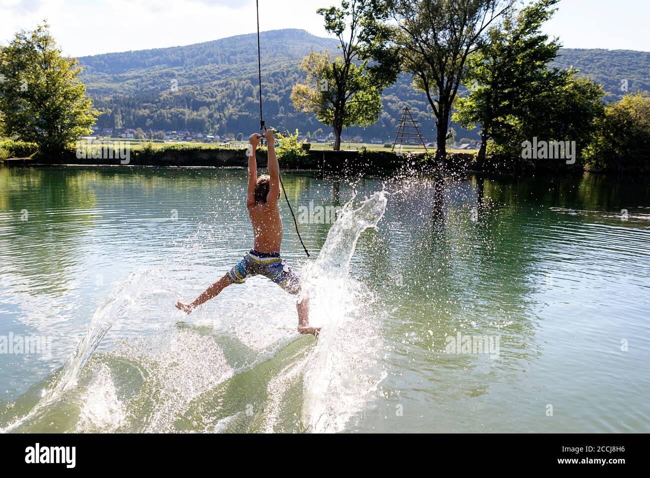 Kids swing over river hi-res stock photography and images - Alamy