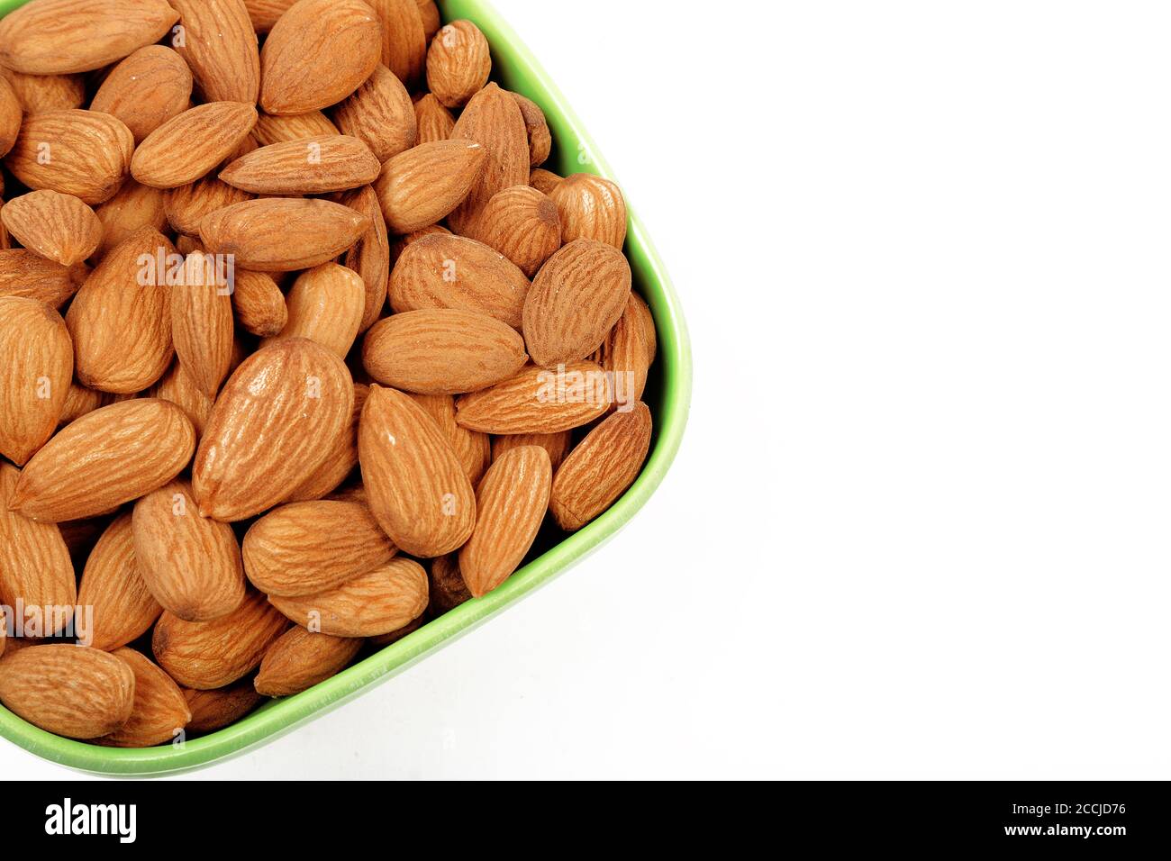 Group of almonds inside and outside bowl isolated on white Stock Photo ...