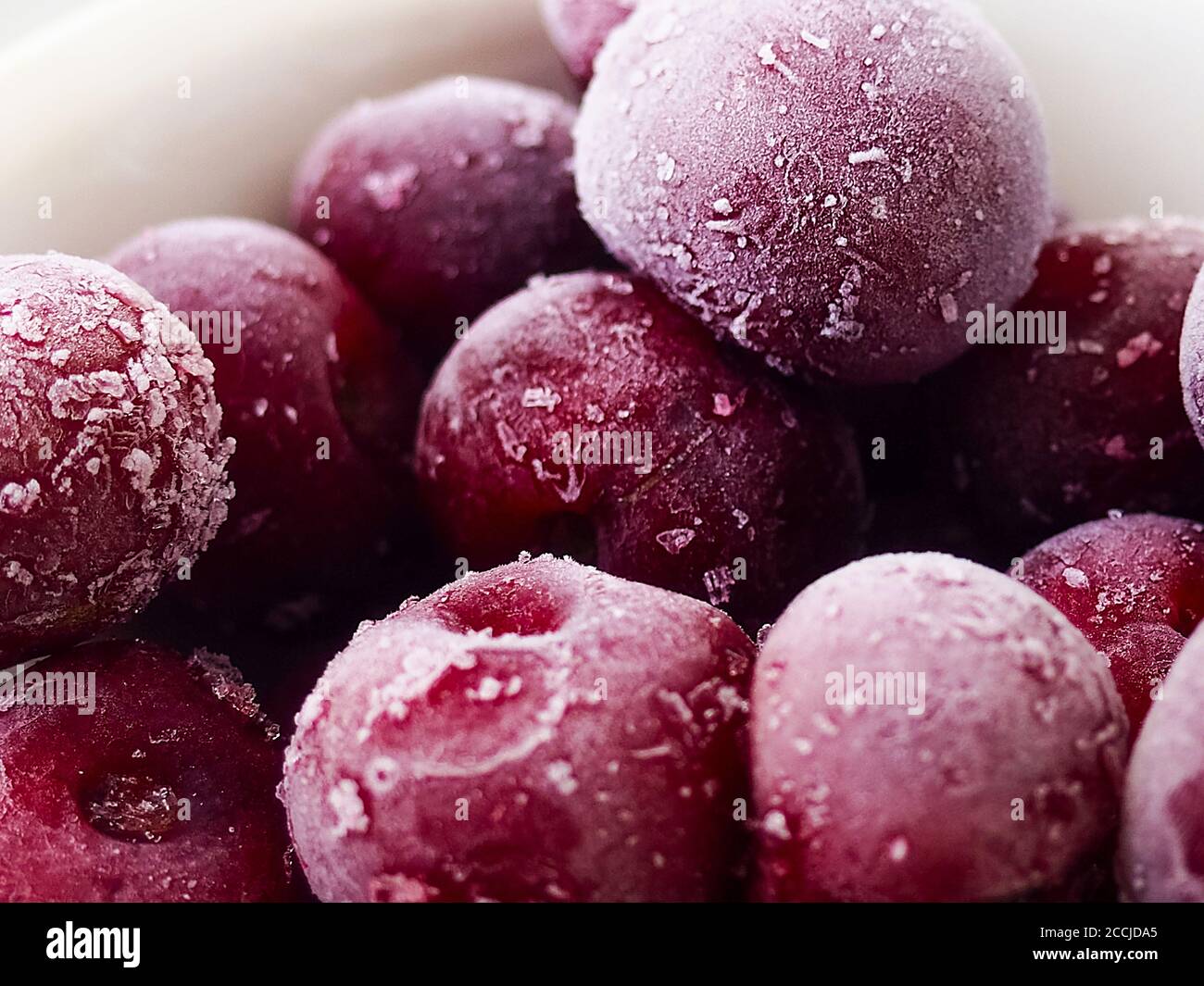 Frozen sweet cherry on black background Stock Photo - Alamy