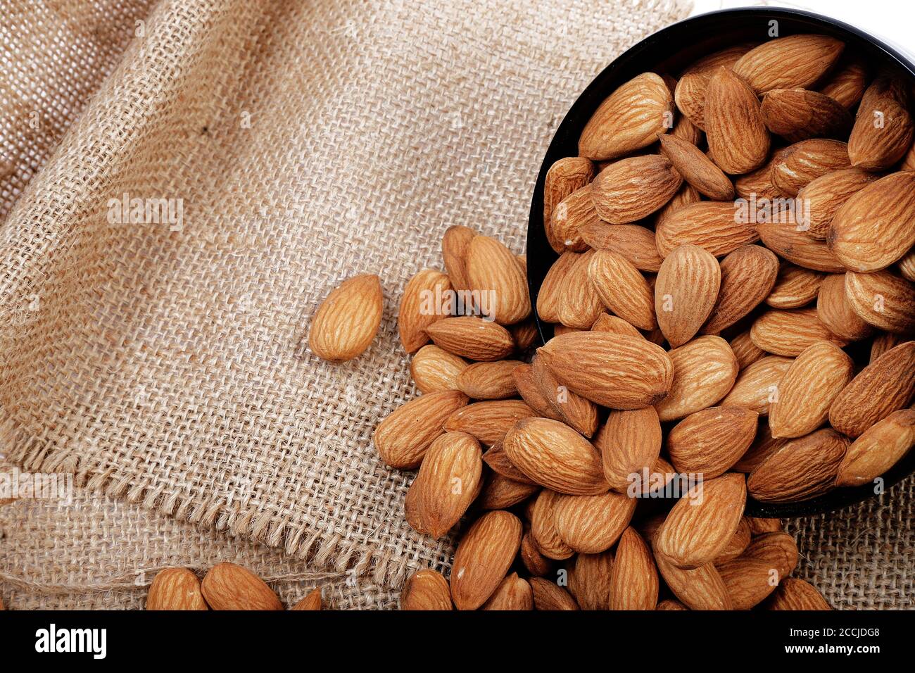 Group of almonds inside and outside bowl isolated on white Stock Photo ...