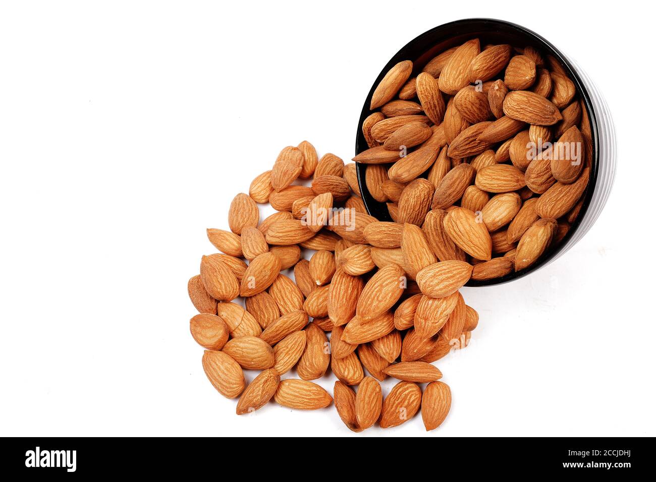 Group of almonds inside and outside bowl isolated on white Stock Photo ...