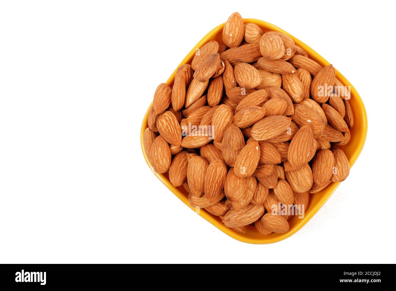 Group of almonds inside and outside bowl isolated on white Stock Photo ...