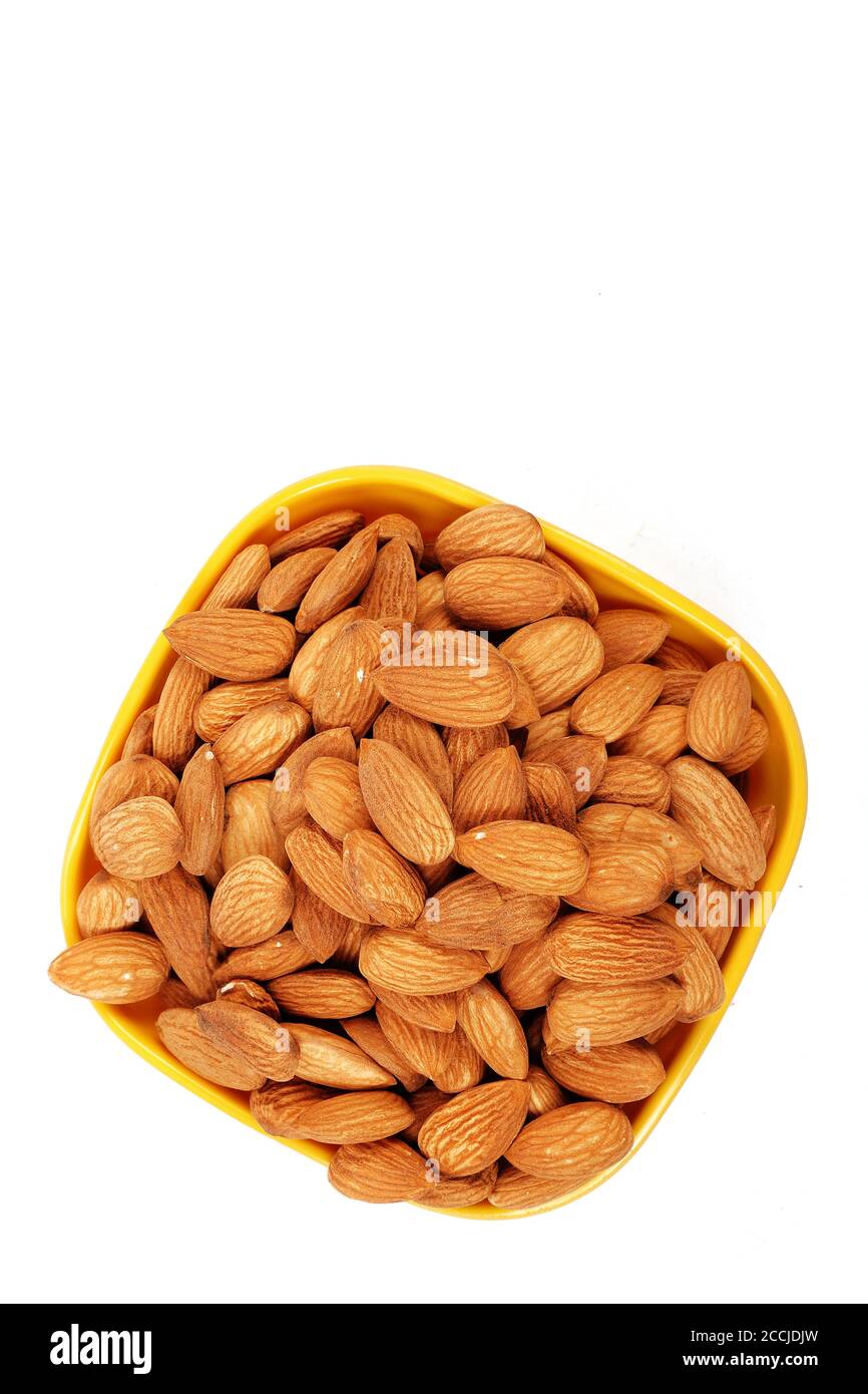 Group of almonds inside and outside bowl isolated on white Stock Photo ...