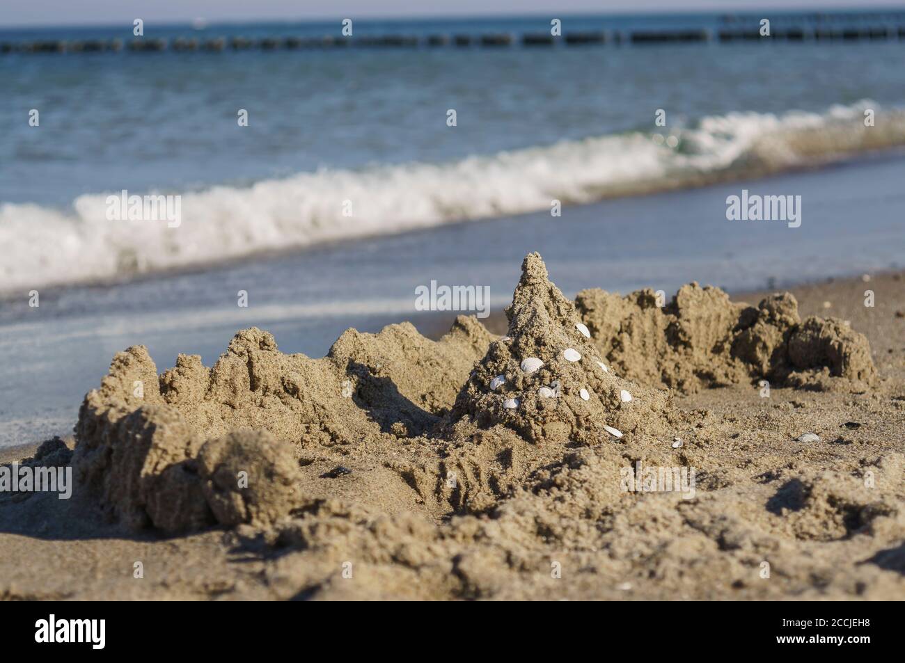 Waves and sand castle on the Baltic Sea beach Stock Photo - Alamy