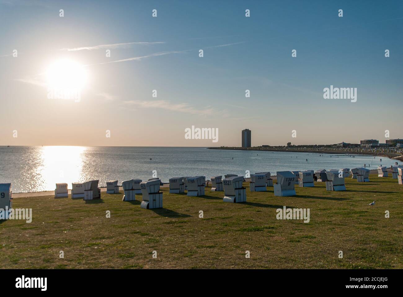 Wide view over the beach and dike of Buesum on a summer evening. An ...