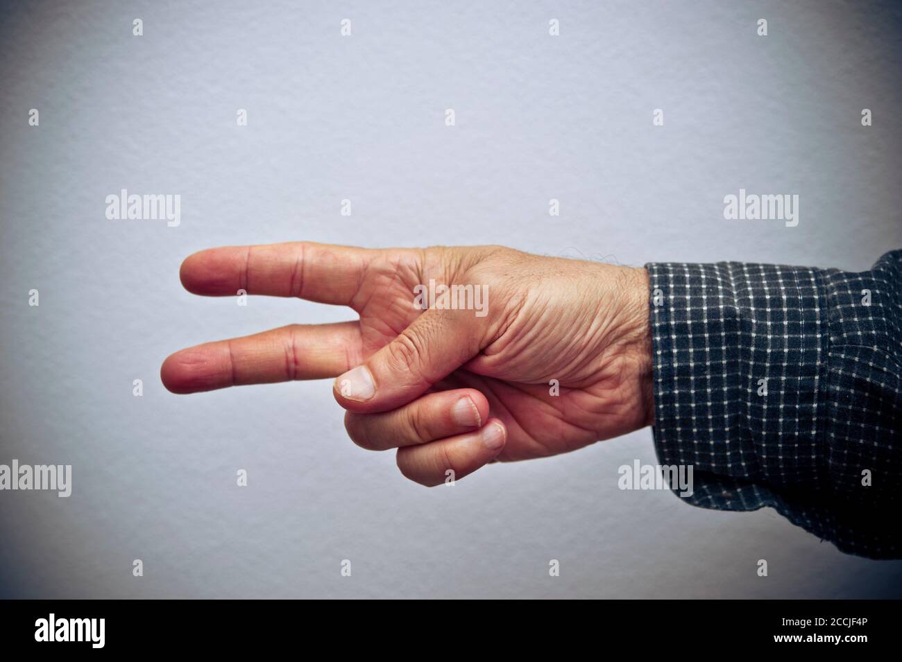 concept for rock scissors paper game, scissors gesture Stock Photo - Alamy