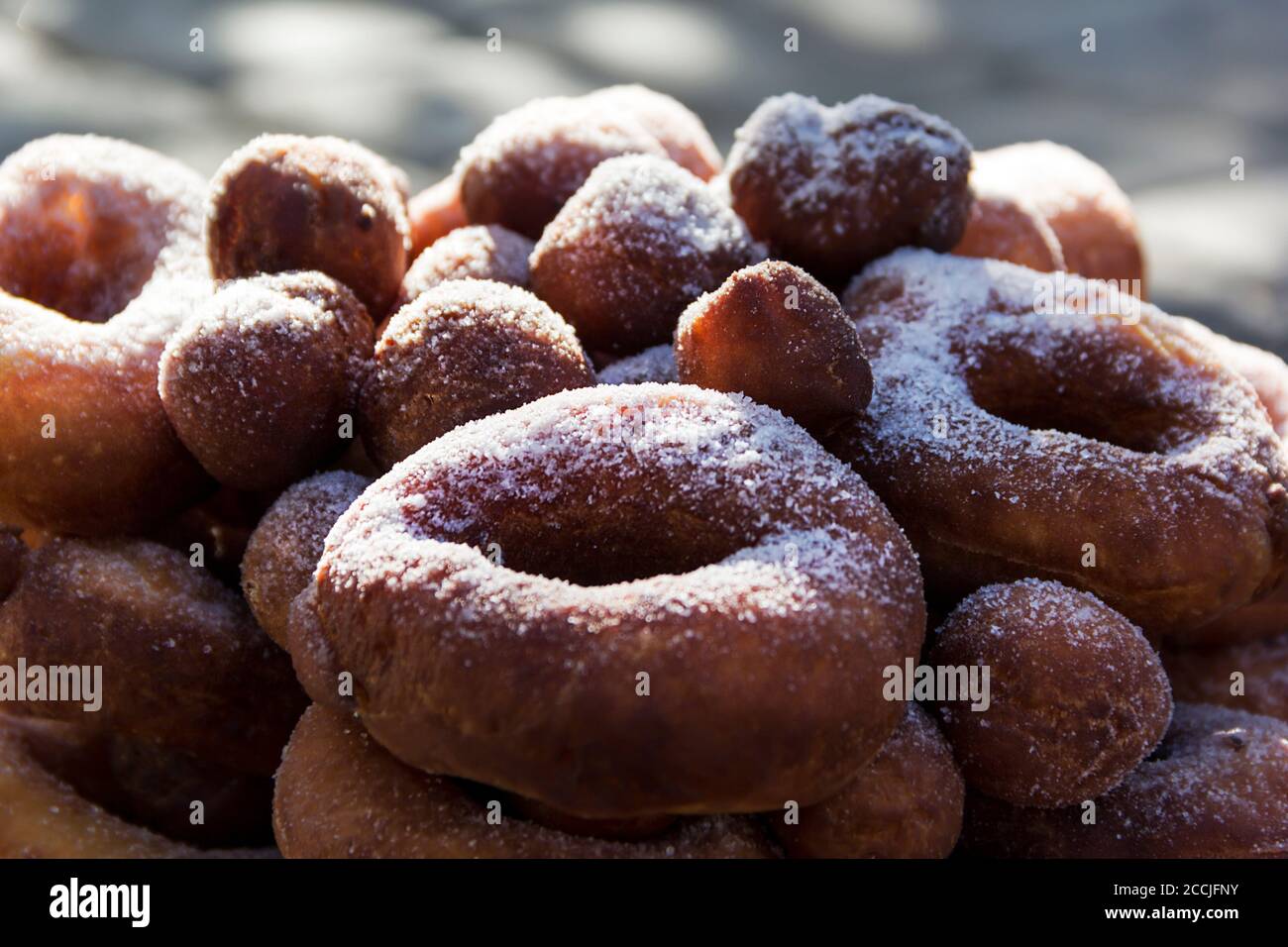 Deep fried donut with powdered sugar, background Stock Photo - Alamy