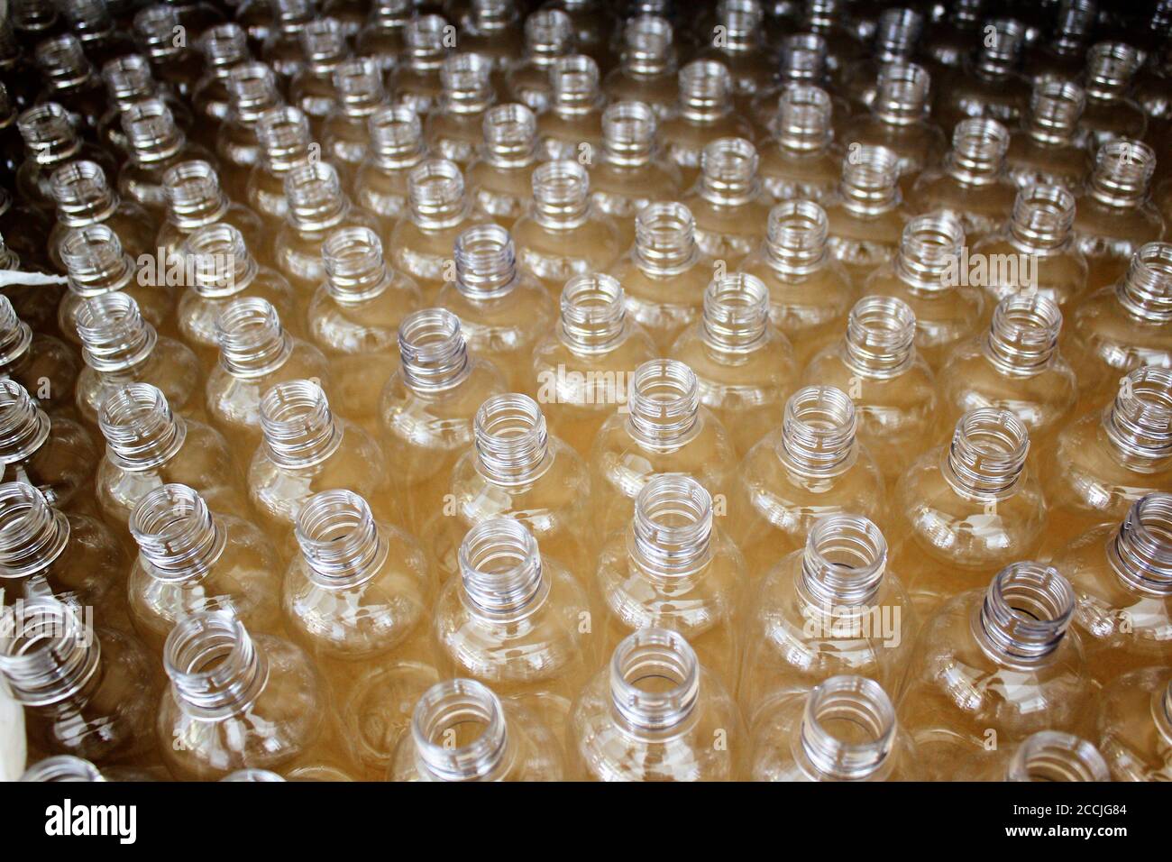 Clean plastic bottles stacked in a factory Stock Photo - Alamy