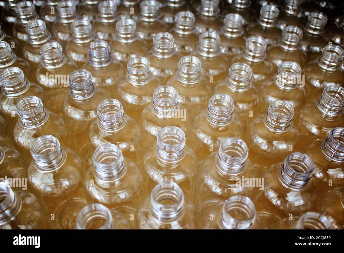 Clean plastic bottles stacked in a factory Stock Photo - Alamy