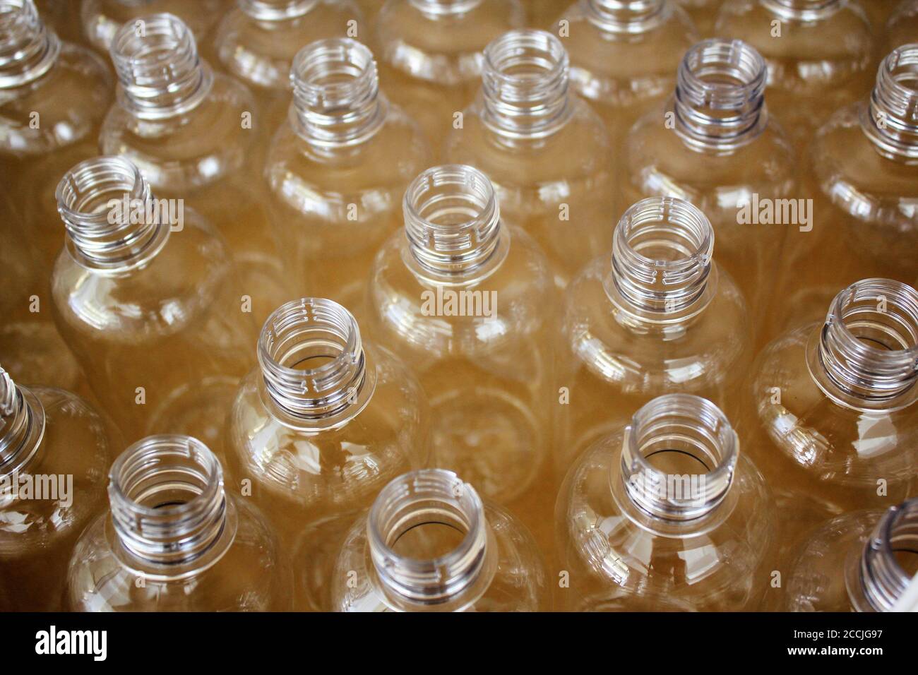 Clean plastic bottles stacked in a factory Stock Photo - Alamy